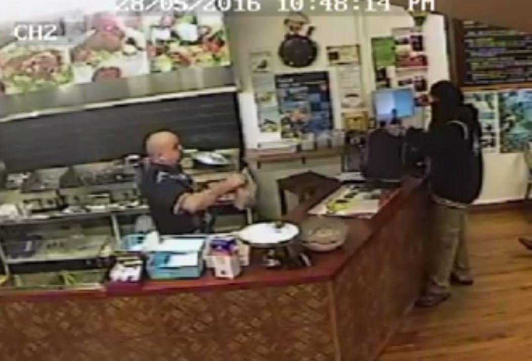 Armed robber walks away with nothing after shop owner ignores him ...
