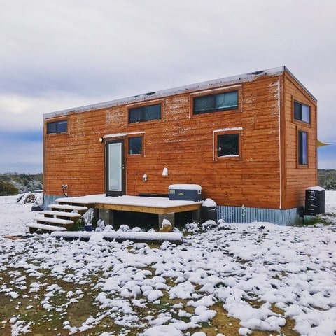 A tiny house with 15 windows and a big amount of storage